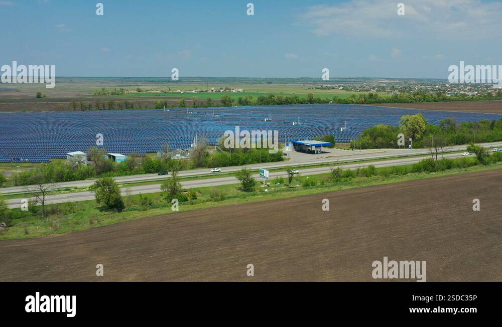 Solar power plant in country near small village next to busy highway ...