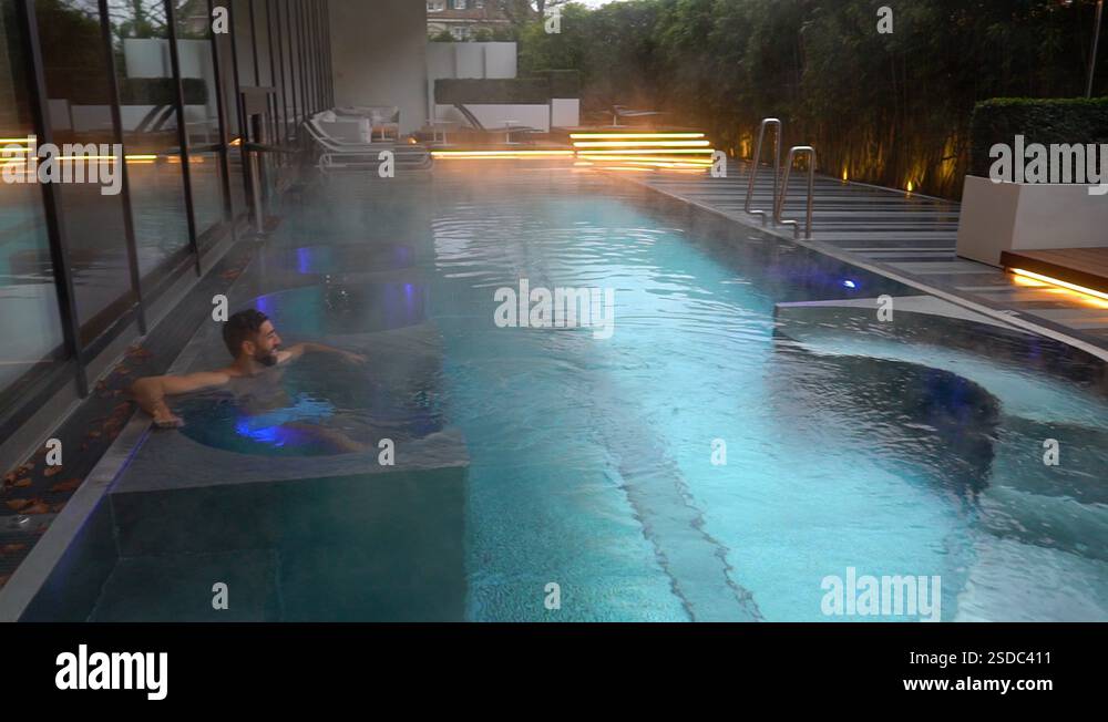 Man bathing in a outdoor pool, steam rising, at a spa resort, in Lausanne Stock Video Footage ...