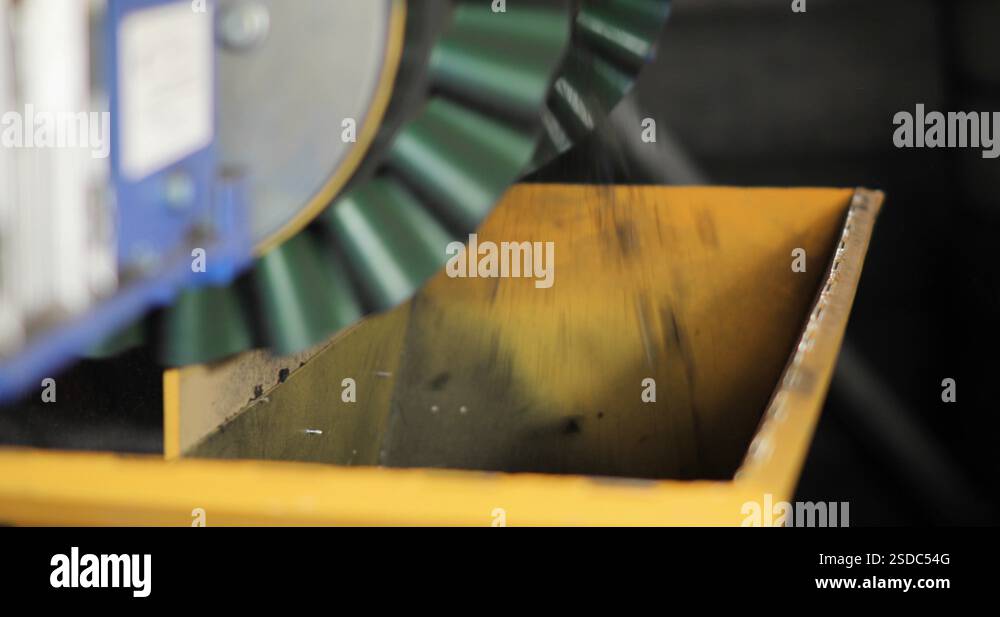 Rubber crumbs from recycled car tyres falling from conveyor belt ...