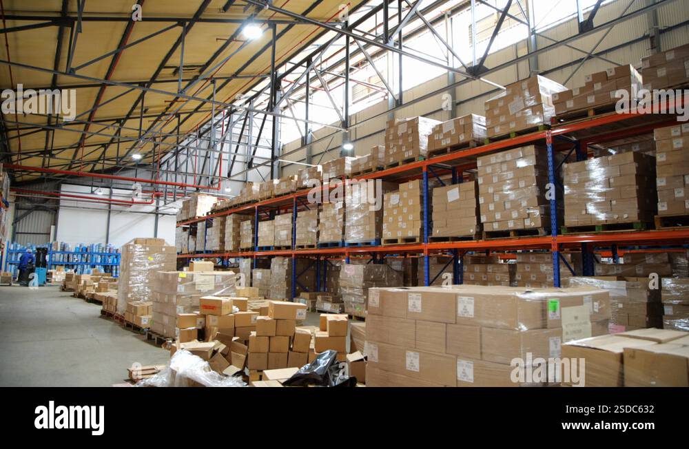 Big warehouse, storage hall with rows and racks holding carton boxes ...