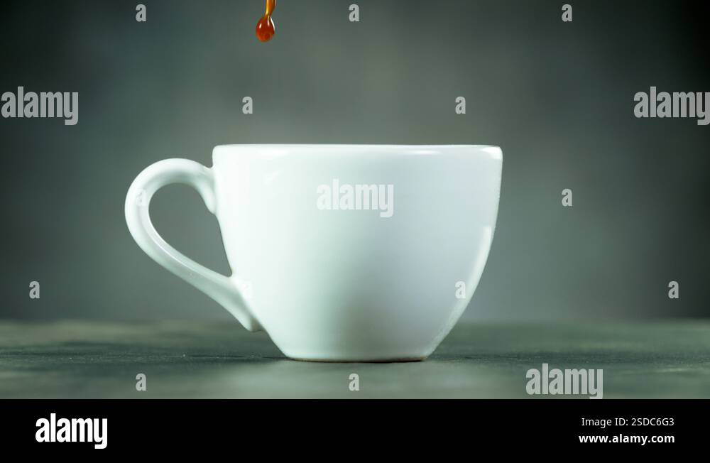 Super slow motion of pouring coffee into cup with copy space Stock ...