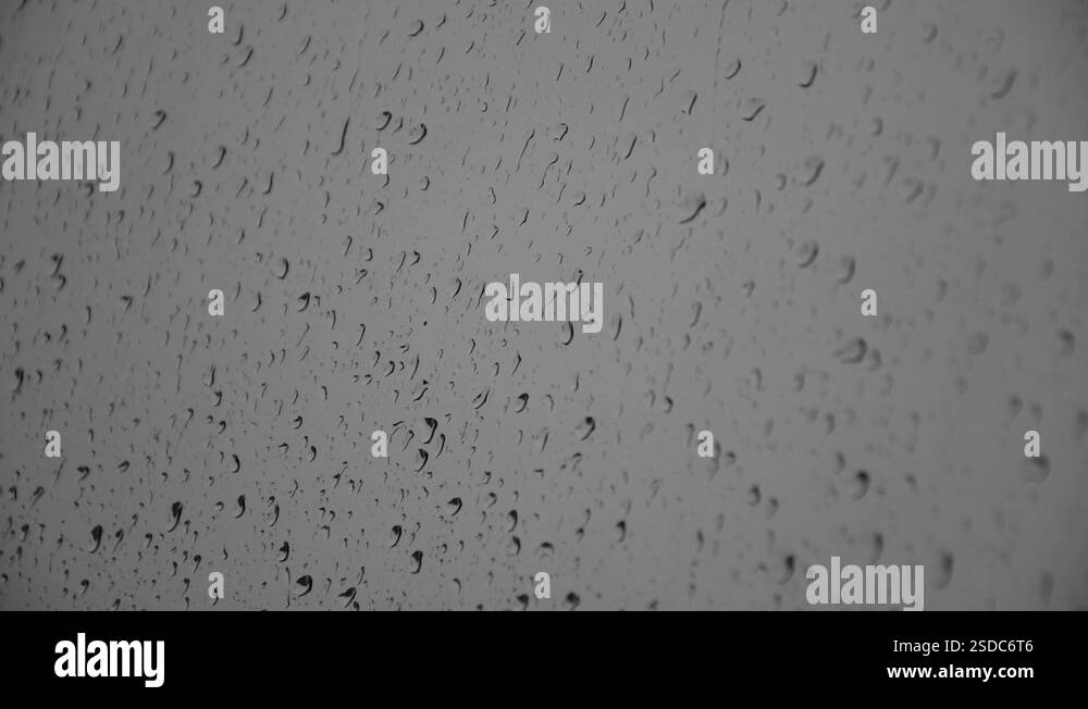 Rain falling on a window, and rinsing down. Very contrast with gray ...