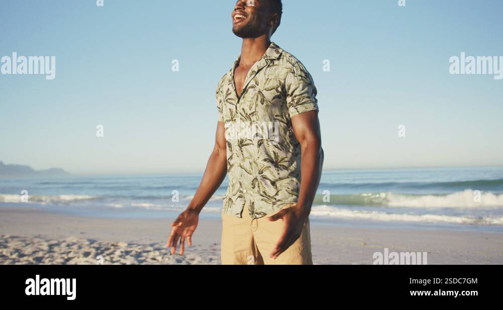 African American man enjoying the fresh air at the beach Stock Video ...