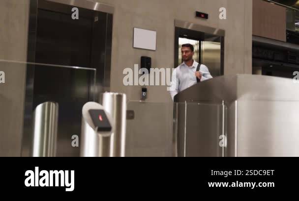 Entering office building, businessman with bag passing through security ...
