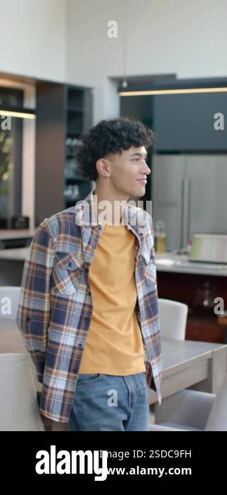 Vertical video: Smiling young person in plaid shirt enjoying peaceful ...