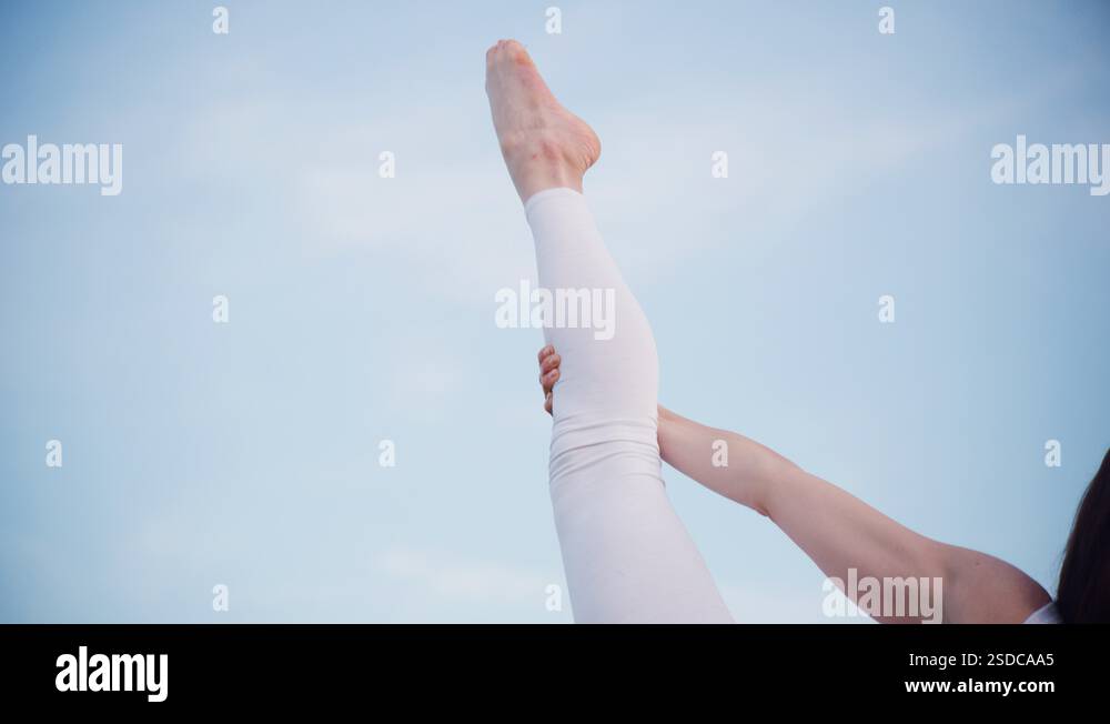 Yoga master doing yoga session at park with view on an ocean Stock ...
