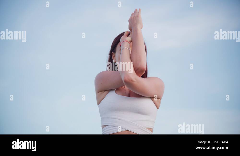Yoga master doing yoga session at park with view on an ocean Stock ...