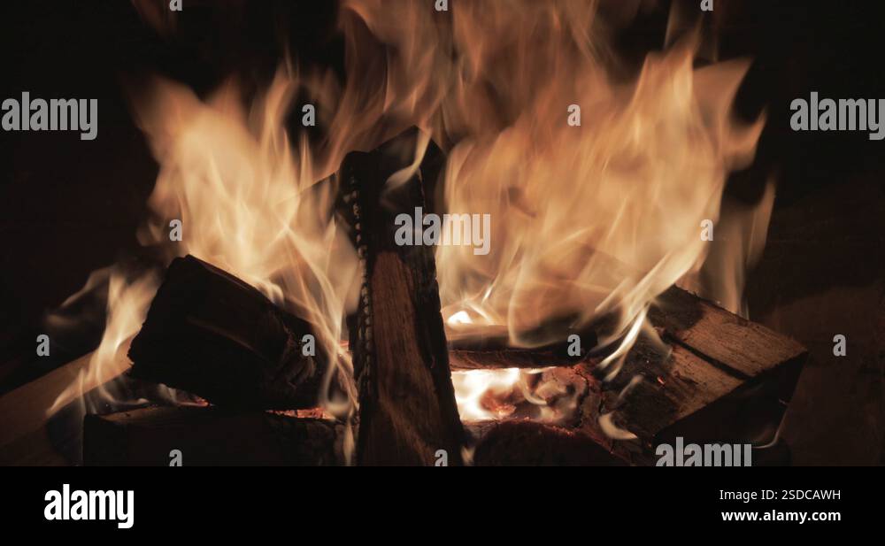 The big fire with firewood in a fireplace, bonfire burning, Brick walls ...
