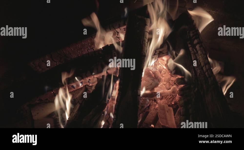 The big fire with firewood in a fireplace, bonfire burning, Brick walls ...