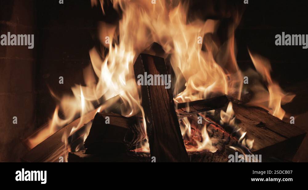 The big fire with firewood in a fireplace, bonfire burning, Brick walls ...
