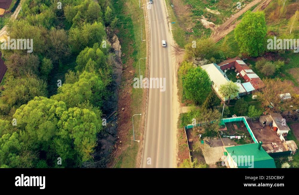 Arial view of white car moving on rural road Stock Video Footage - Alamy