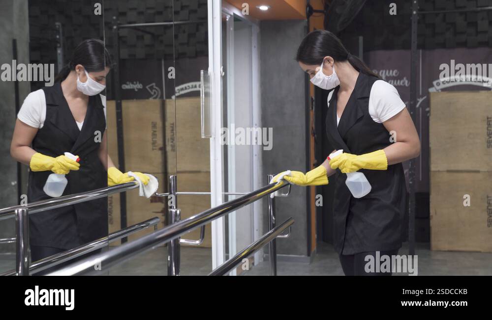 woman cleaner disinfects gym from coronavirus cleans workout area Stock ...