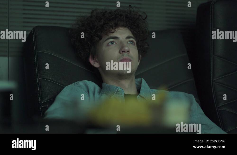 Scary movie in a cinema, man watching a horror movie on a big screen, a ...