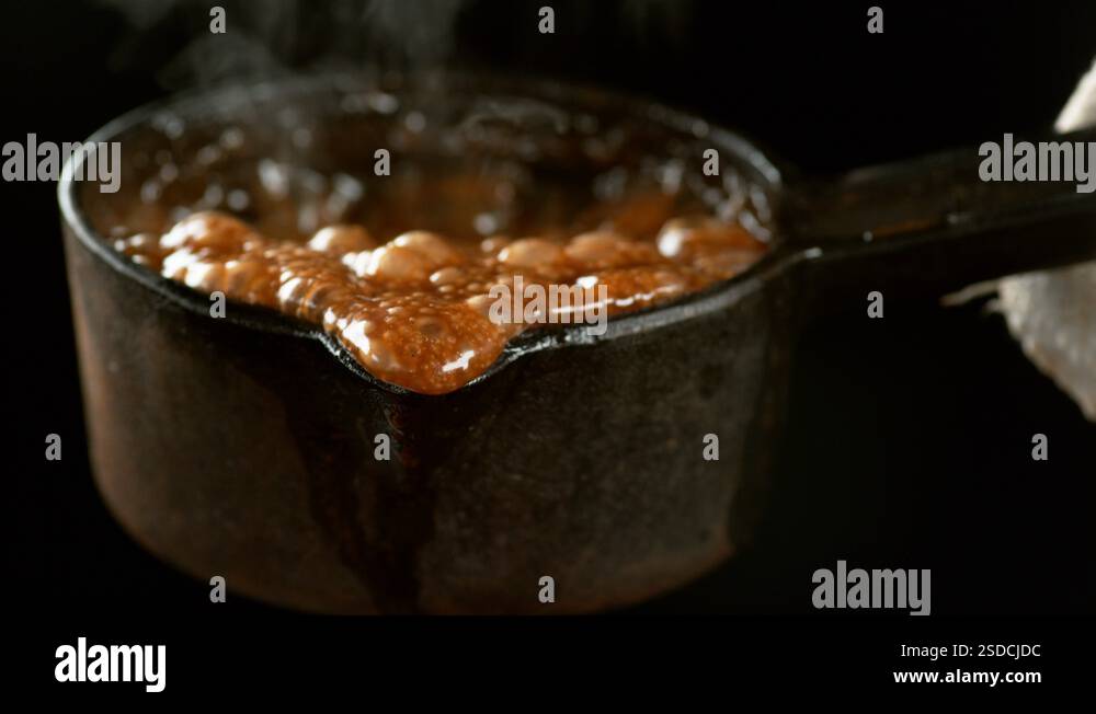 Molten boiling caramel sauce pouring in slow motion. Shot with Phantom ...