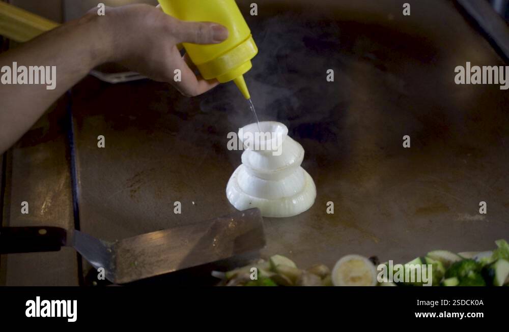Traditional onion volcano in teppanyaki dining gets filled with oil ...