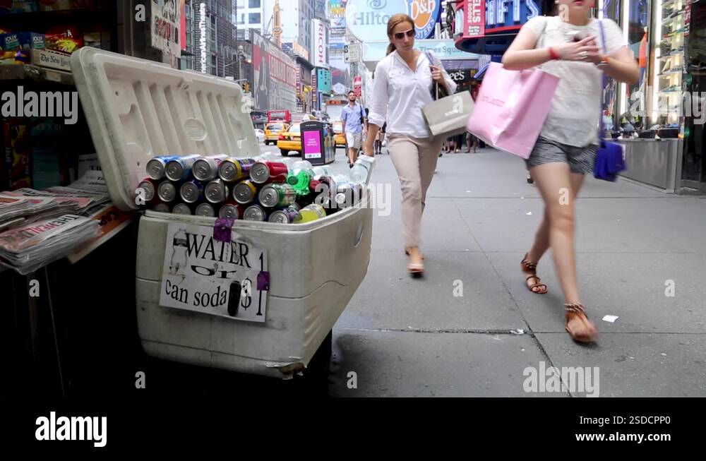 People walk by water and soda in the streets of New york city, united ...