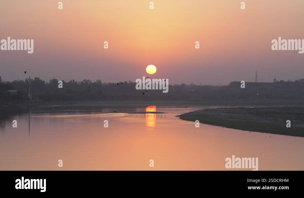 Slow panning on a beautiful river sunset. Shot on telephoto and slow ...