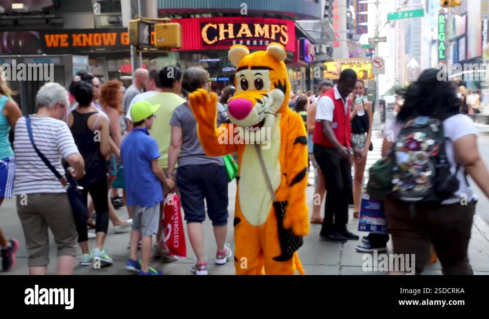 People walk by a city mascot at Times Square in the streets of New york ...