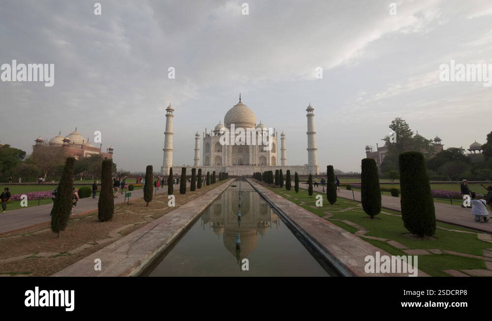 wide shot of the taj mahal on its reflection on water on a spring ...