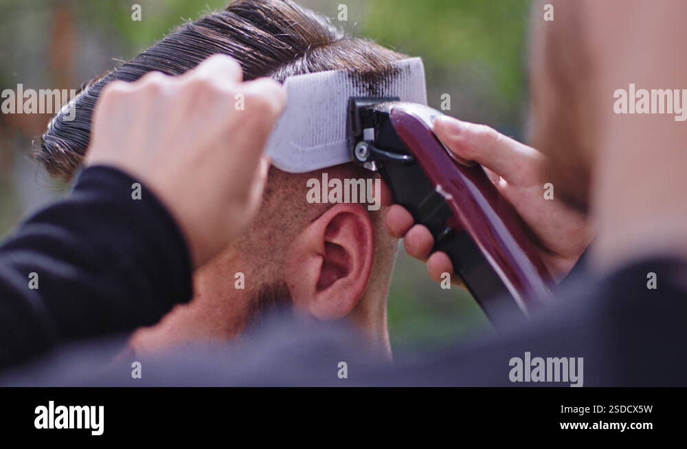 Details closeup in the garden at home barber man doing a haircut done ...