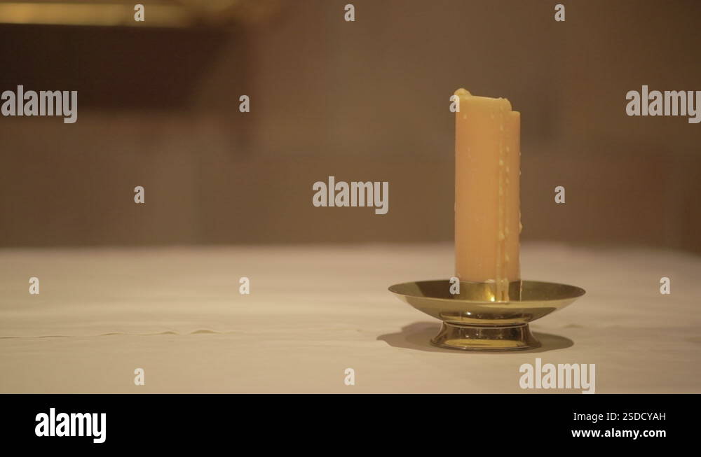 Unlit candle in silver candle holder standing on table, static shot ...