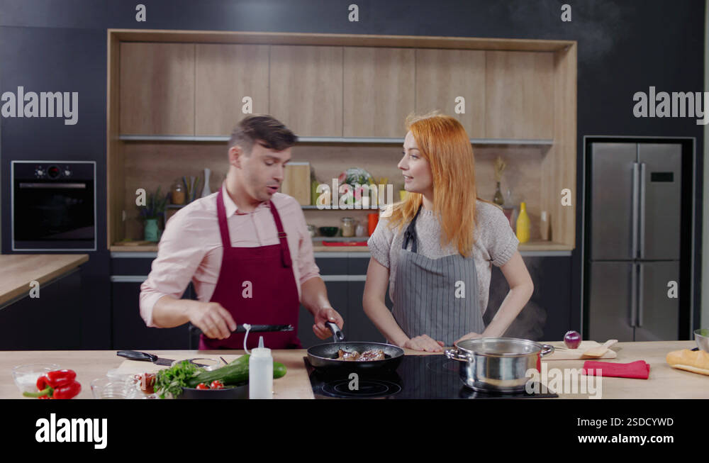 Cooking show hosts chefs, male and female, cooking meat. TV cooking ...