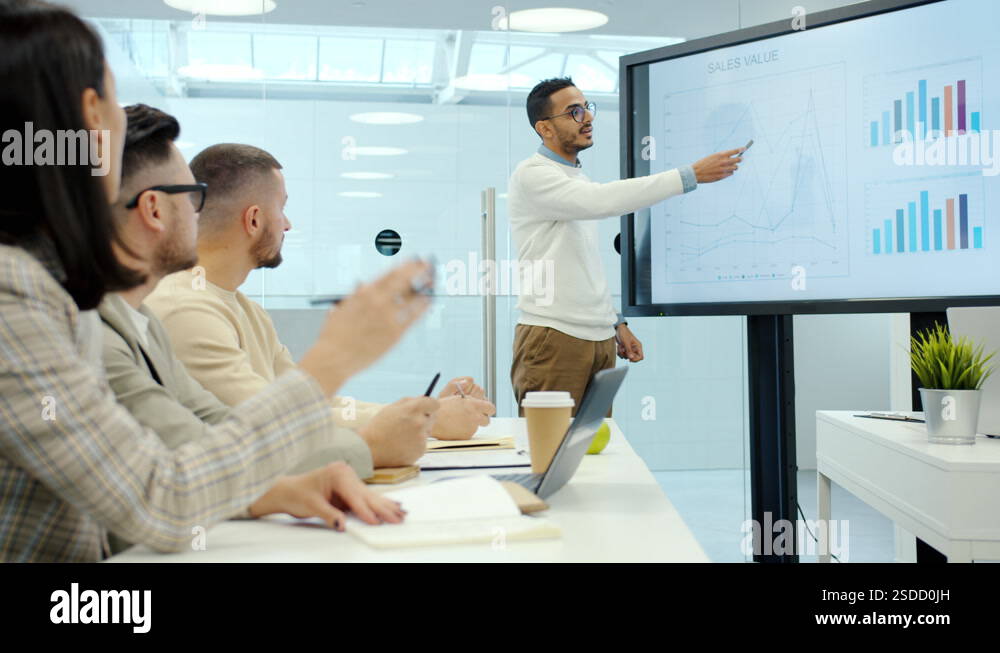Arabian man employee giving presentation to group of colleagues in ...