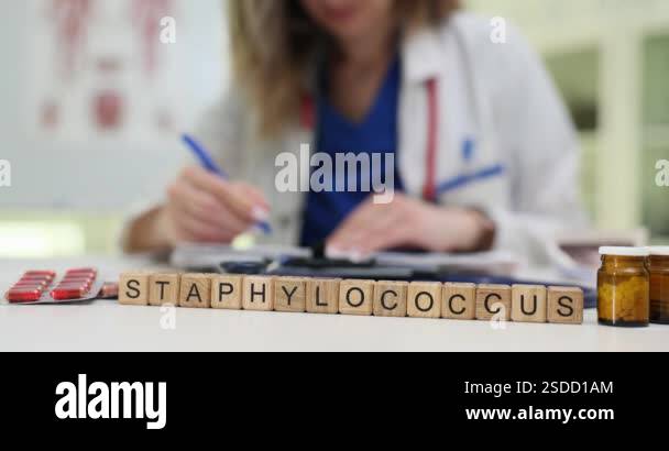 A healthcare worker studies Staphylococcus in a lab, highlighting ...