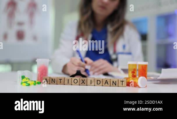 A healthcare professional writes notes related to antioxidants in a lab ...