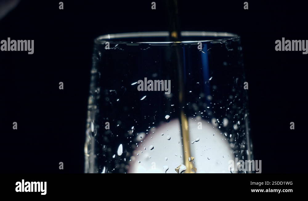 jet of a refreshing drink flows beautifully into a glass beaker Stock ...