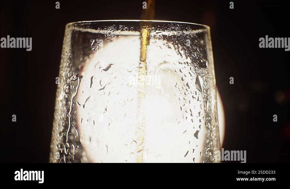 jet of a refreshing drink flows beautifully into a glass beaker Stock ...