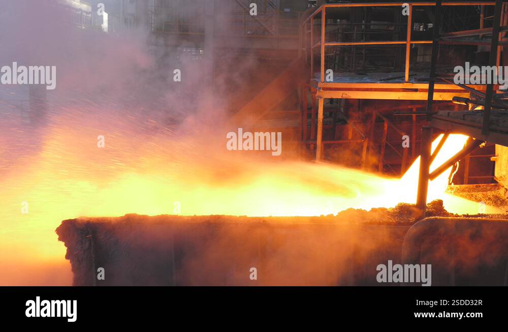 fiery red slag liquid spews out of furnace in a iron factory Stock ...