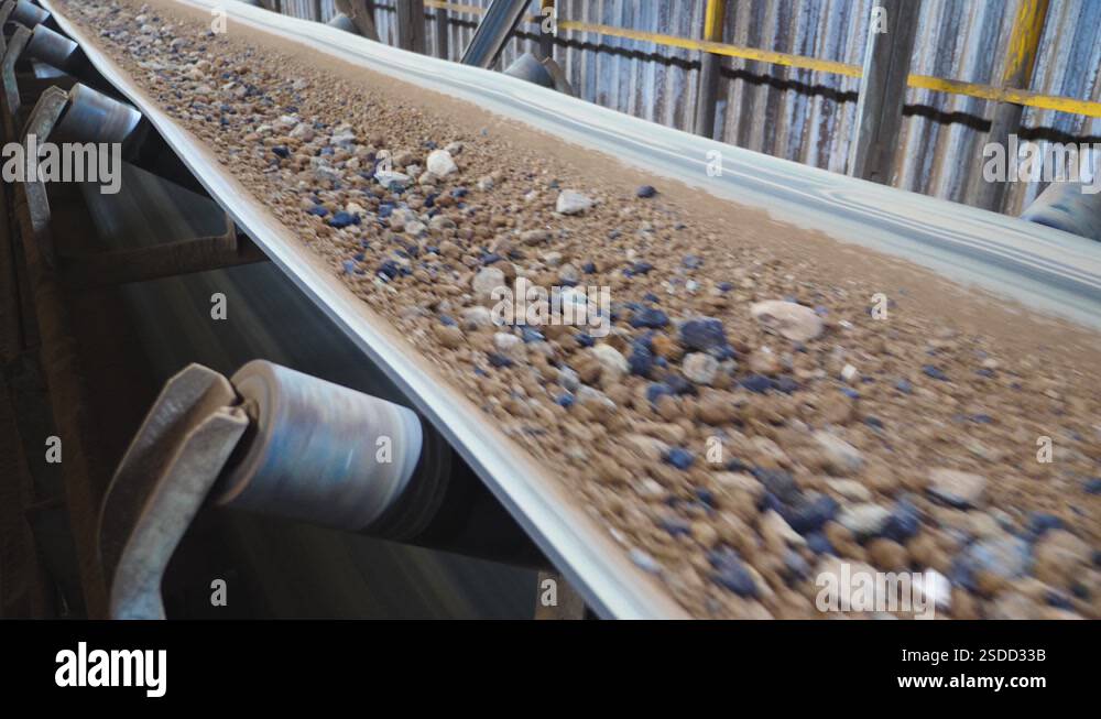 The ore belt conveyor in the steel plant is transporting ore raw ...