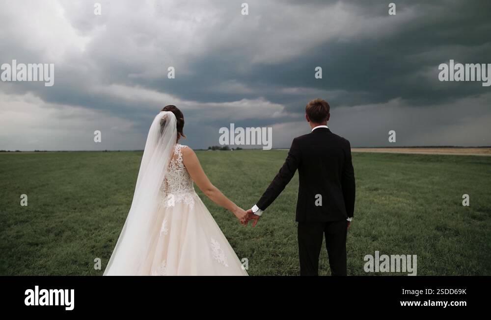 Bride and Groom Standing In The Field And Wedding Without Guests Stock ...