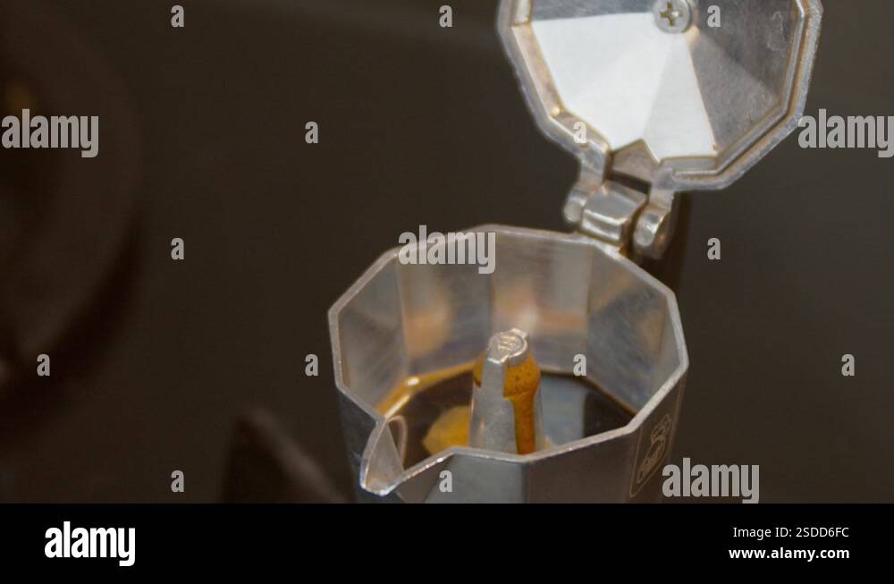 Stovetop moka pot heating-up coffee on hob, traditional coffee maker ...