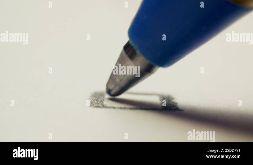 Pen draws a check mark on a white background paper, macro shot Stock ...
