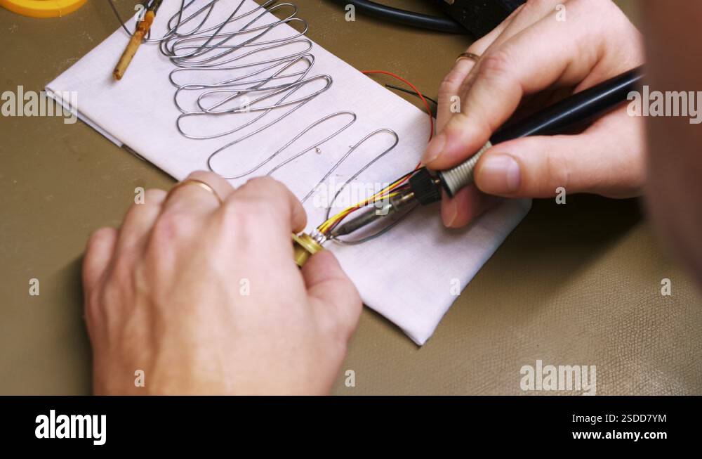 Lab technician using a soldering iron connects the wires Stock Video ...