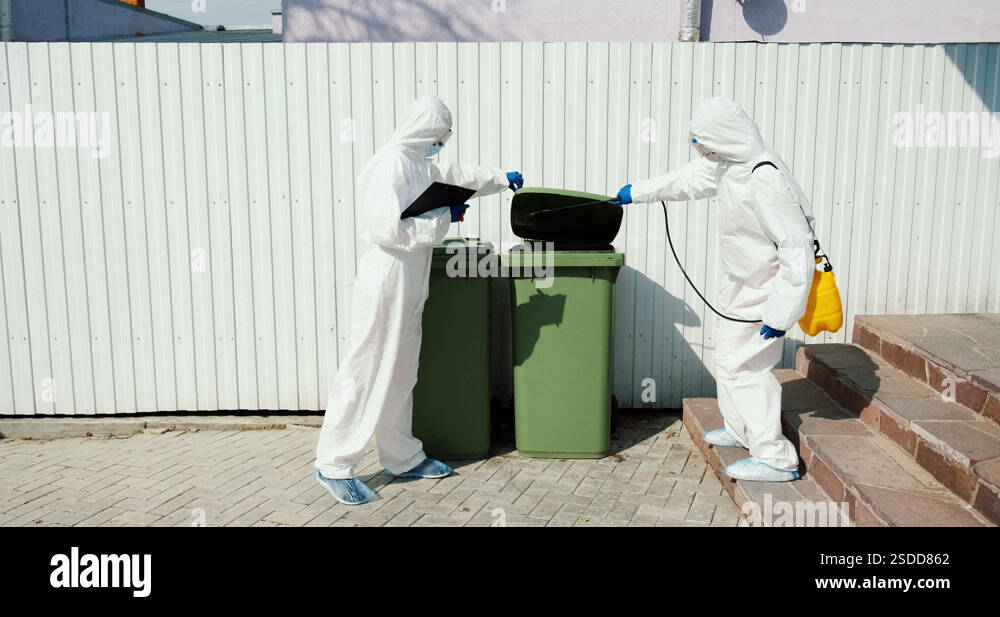 Sanitation doctors disinfect trash bins, garbage containers. Sanitation ...