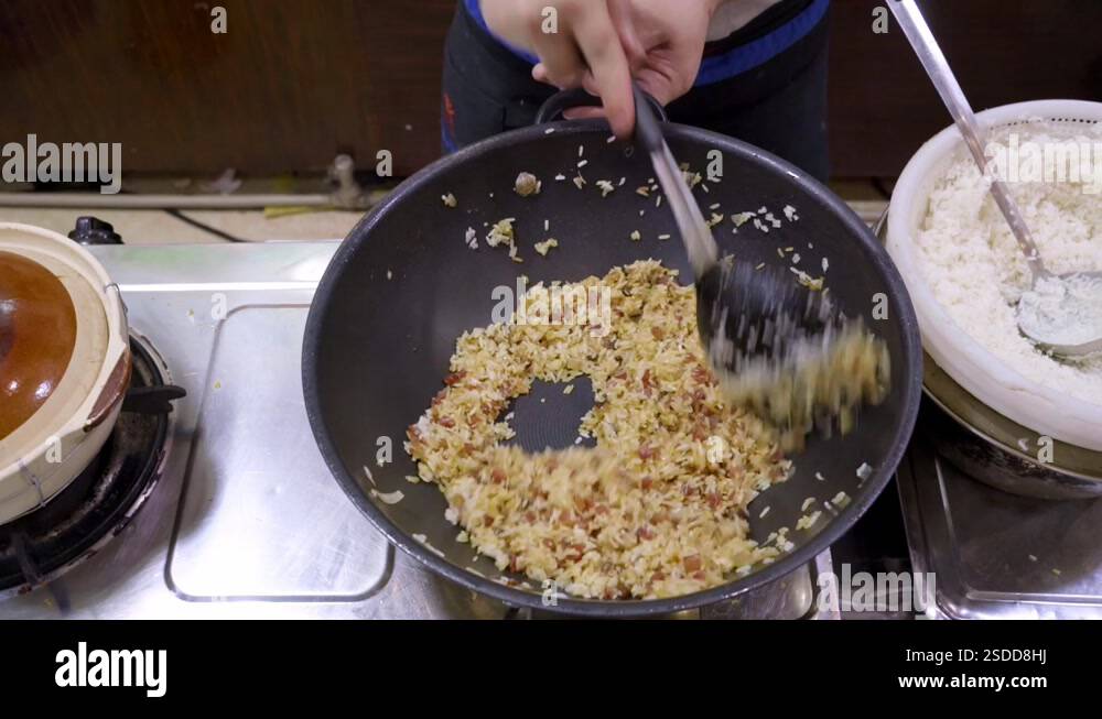 Above view of hands cooking Chinese Sticky Rice in wok on stove Stock ...