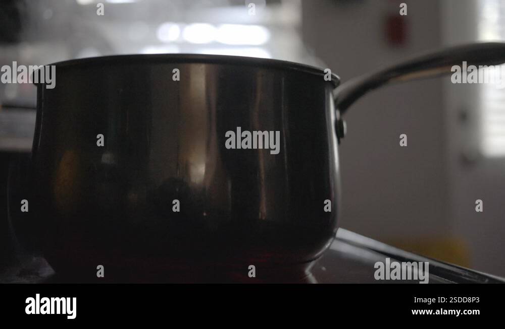 Steaming Black Pot On Top Of The Electric Gas Stove In The Kitchen ...