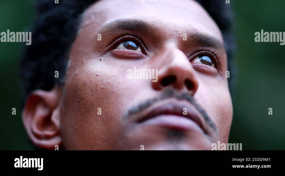 Contemplative man closing eyes. Close-up face portrait of mixed race ...