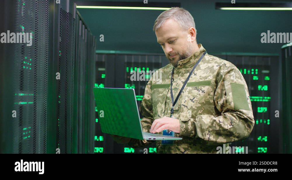 Military Caucasian US army male officer typing on laptop computer while ...