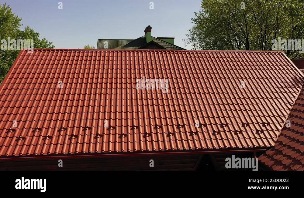 Rooftop of house covered with stylish red color lightweight metal ...