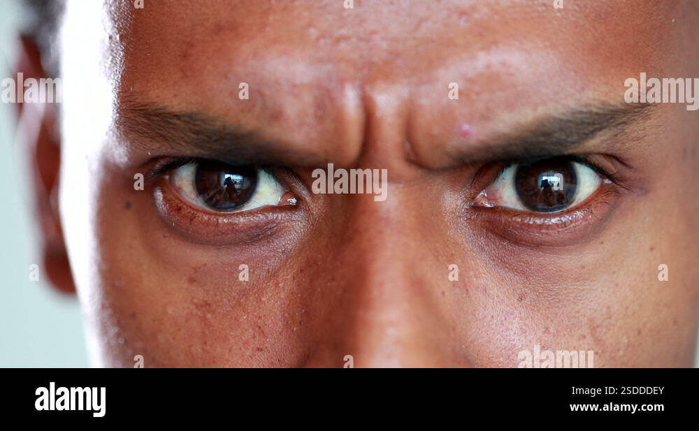 Suspicious Man has a serious look on his face. Closeup of man frowning ...