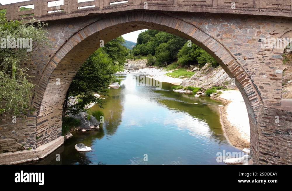 Aerial 4K shot of stone bridge and river Pilima Xanthi in Greece Stock ...