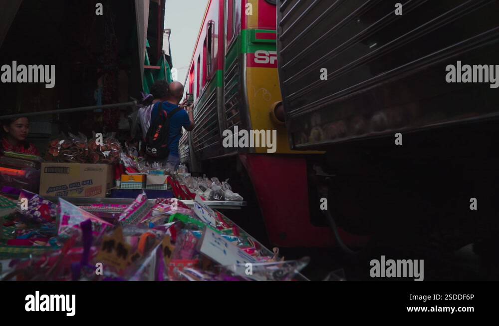 Full shot, Train Passing by in Maelkong Samut Rail Road Market ...