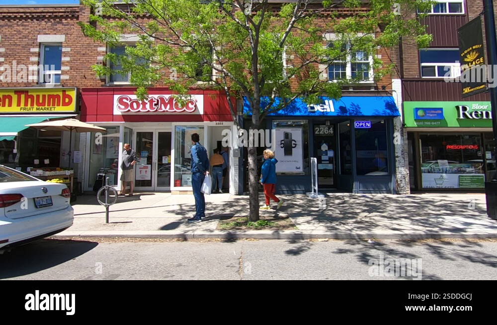 POV side view of Toronto streets with retail stores and people during ...