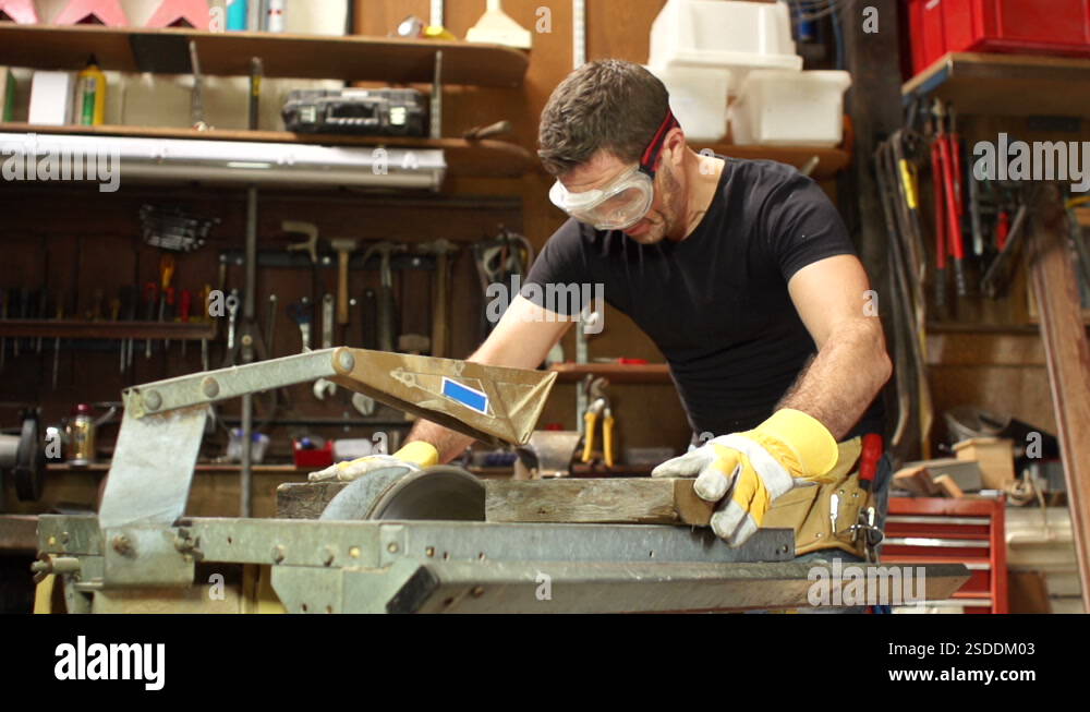 Carpenter / Joiner is in his workshop using a circular saw. Slow motion ...