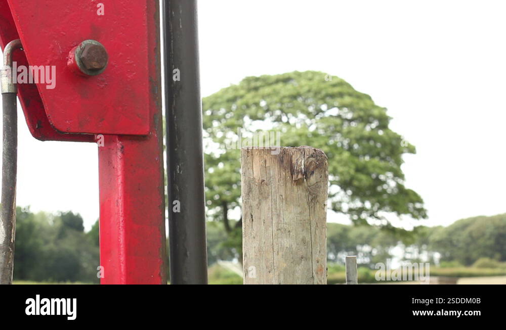 Post Driver machine on the back of a Tractor. Knocking in fence posts ...