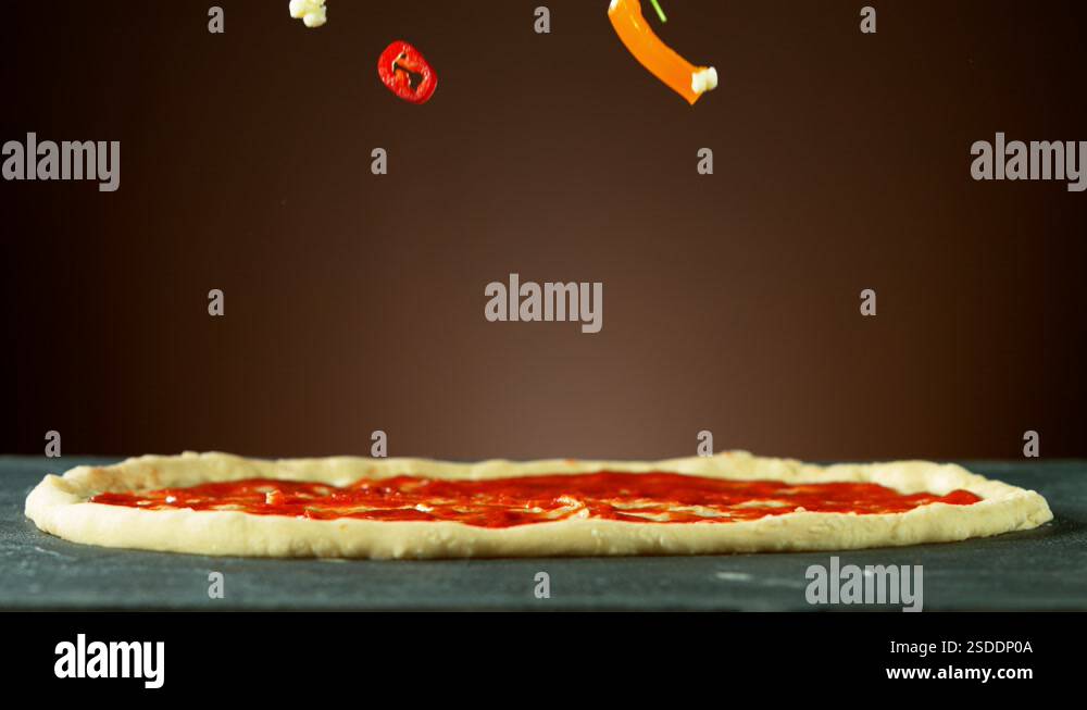 Super slow motion of falling pizza ingredients on yeast dough Stock ...